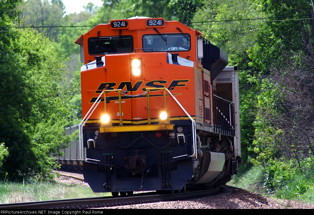 BNSF 9241, EMD SD70ACe, drops down grade with westbound empties